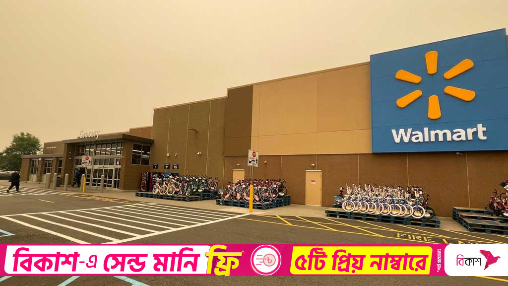 Walmart boosts sales outlook, shares surge to record